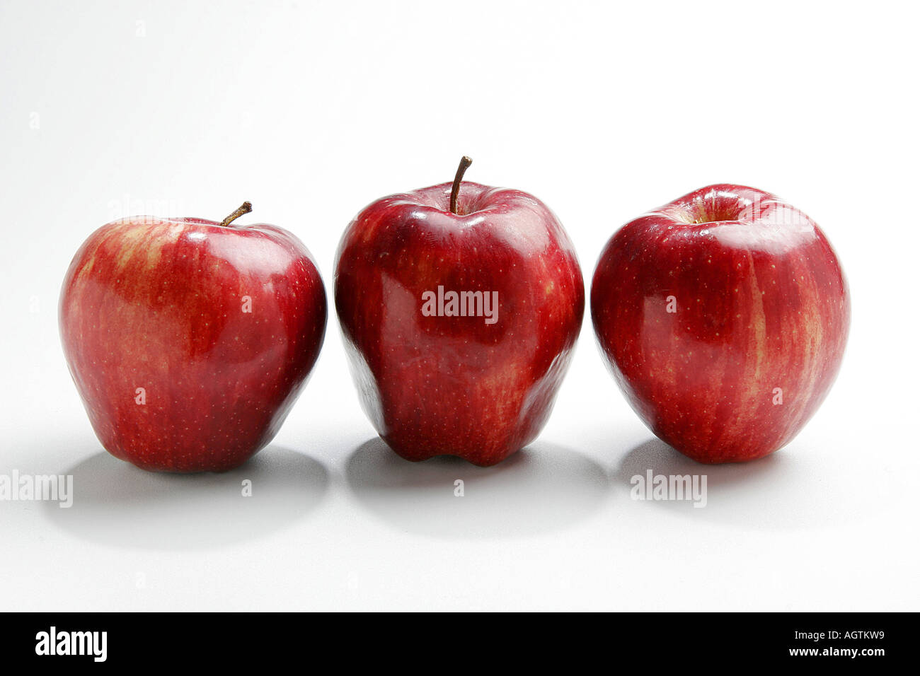 Three Red Apples on white background Stock Photo - Alamy
