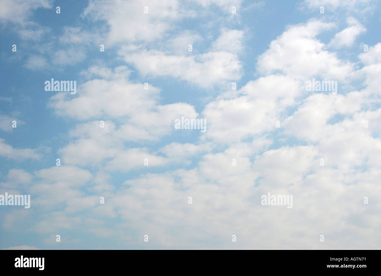 Blue sky with fluffy white clouds Stock Photo - Alamy