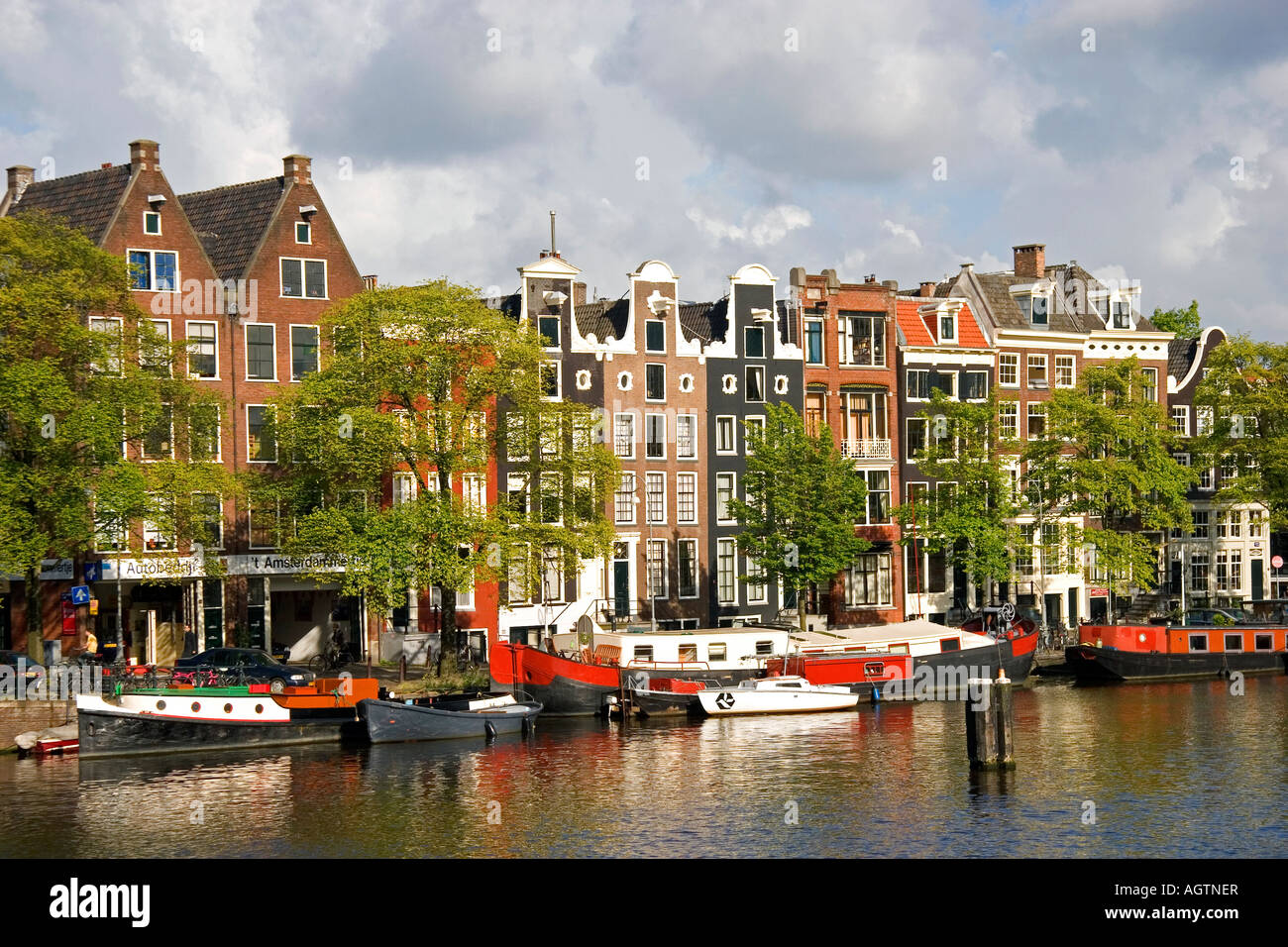 Row houses along the Amstel River in Amsterdam Netherlands Stock Photo ...