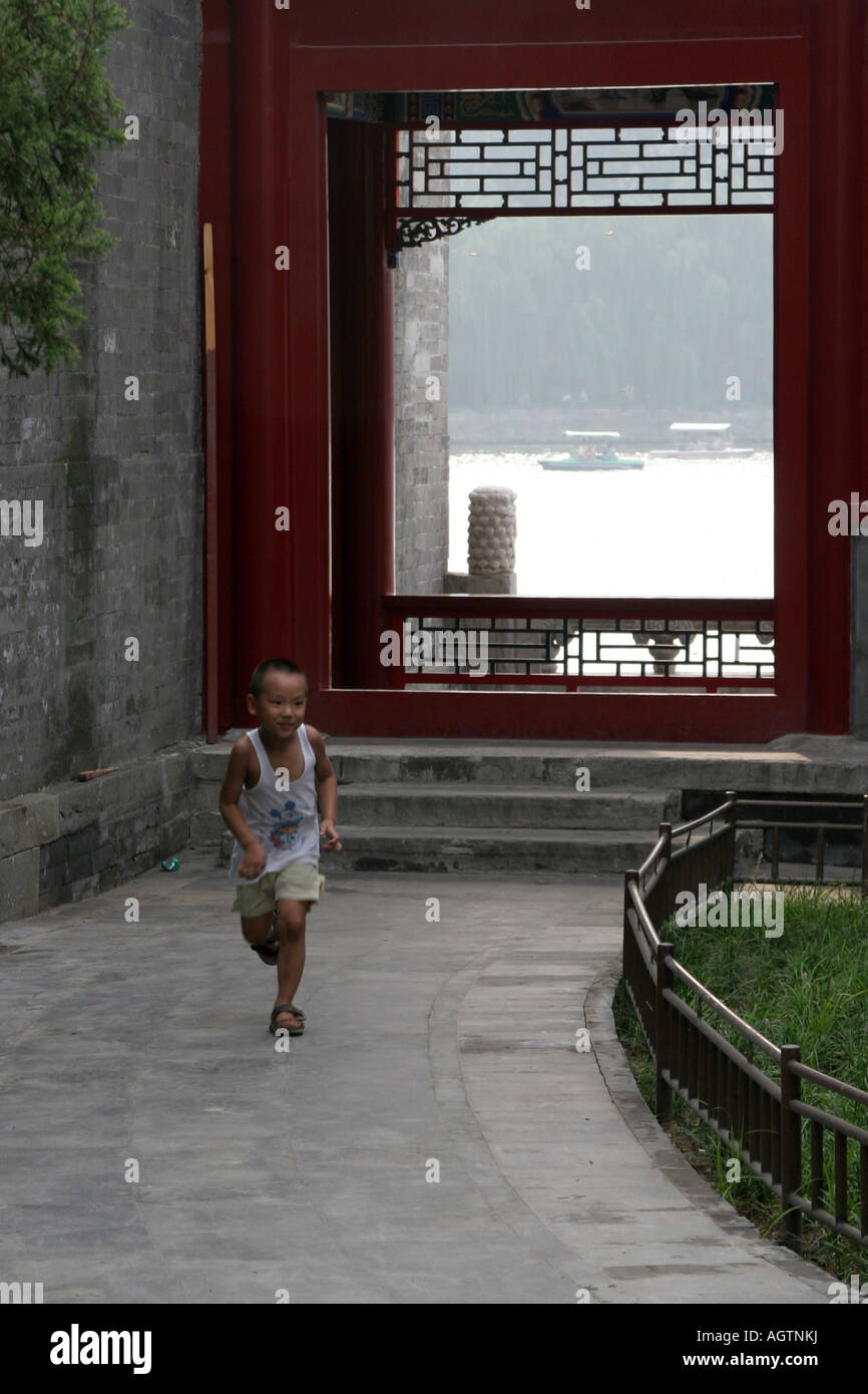 young chinese boy running in Beihai park Beijing China August 2007 ...