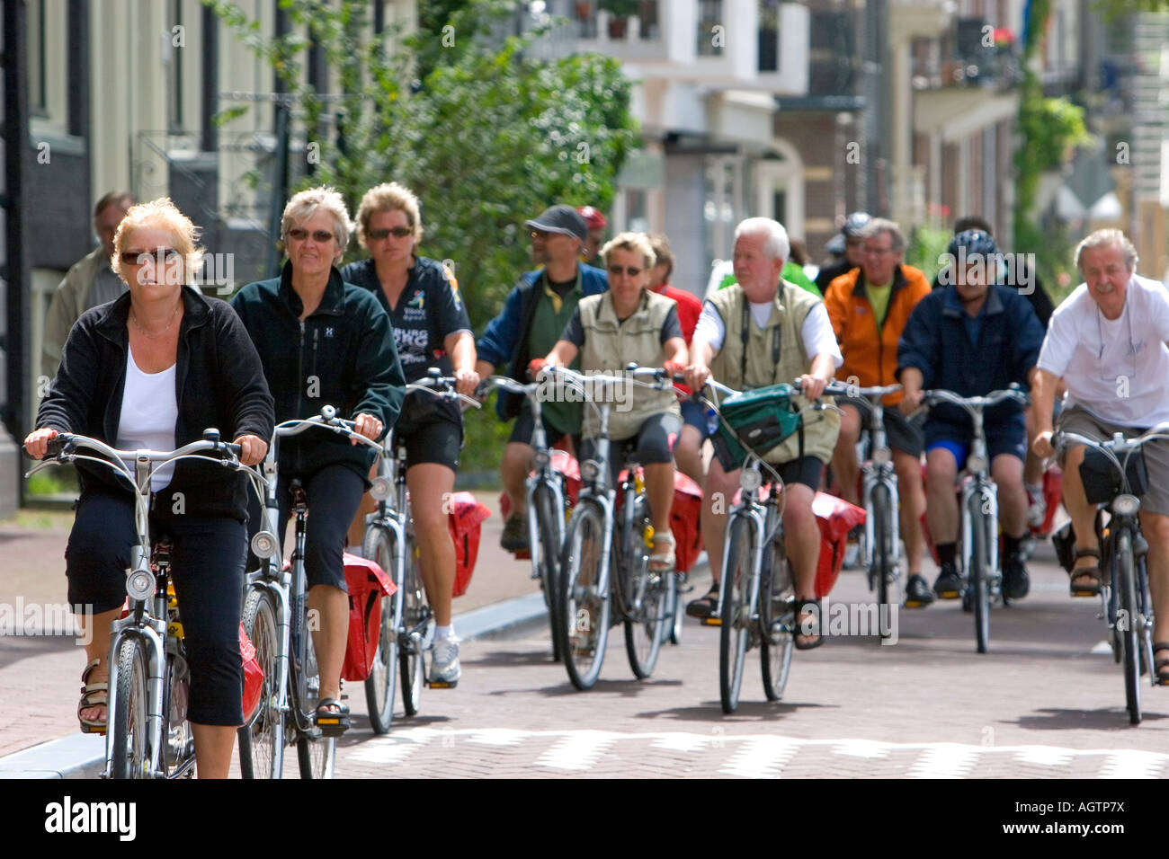 People riding bicycles on the street in Amsterdam Netherlands Stock ...