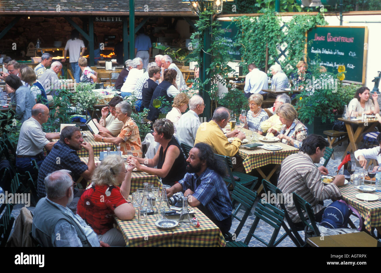 People sitting at the wine bar Zum Martin Sepp in the winegrower ...