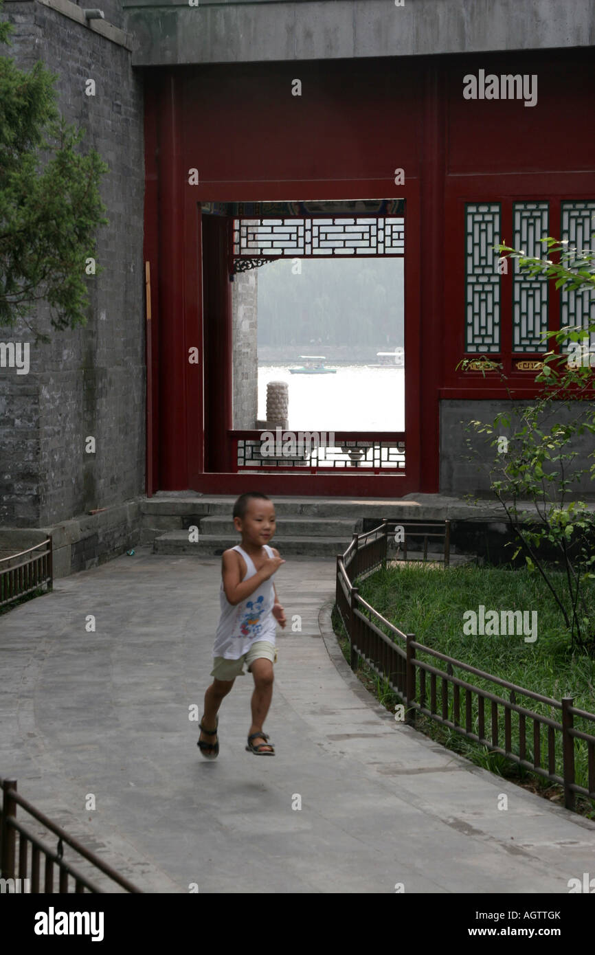 young chinese boy running in Beihai park Beijing China August 2007 ...