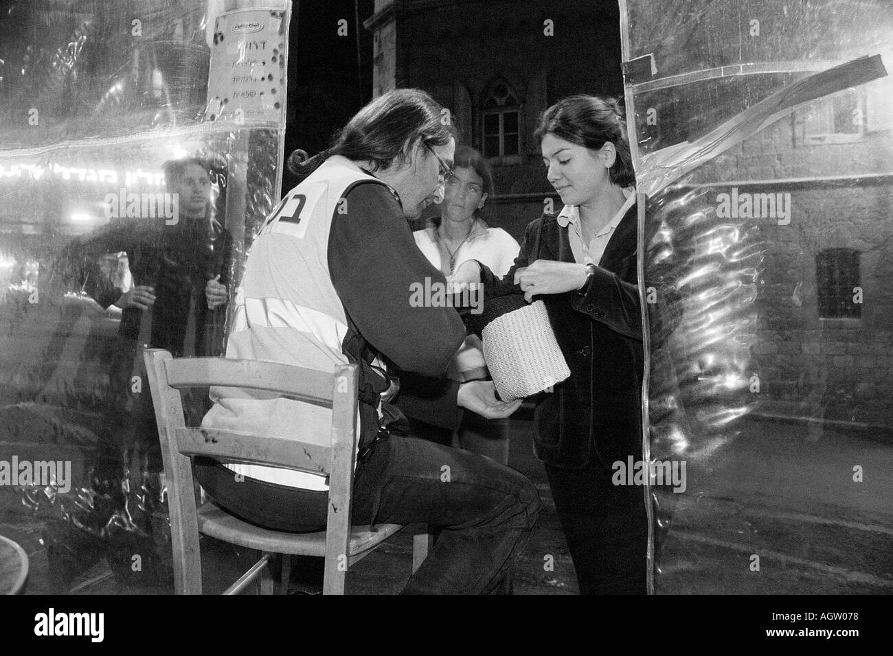 Security guard checking Black and White Stock Photos & Images - Alamy