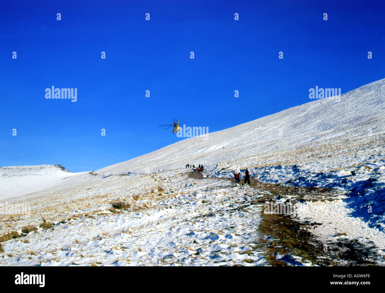 rescue helicopter above path leading to summit of corn du brecon ...