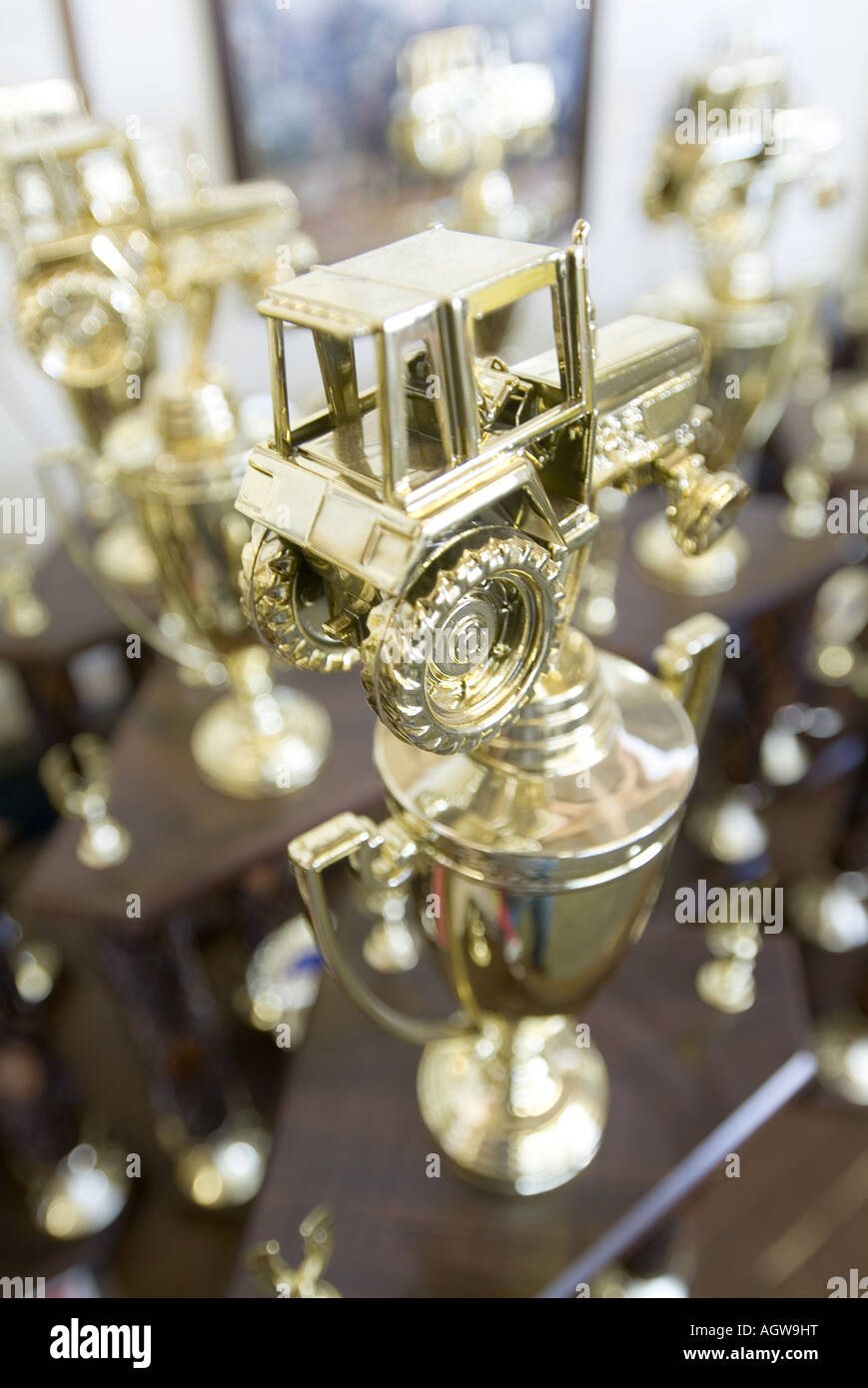 Golden tractor trophies at country fair Stock Photo - Alamy