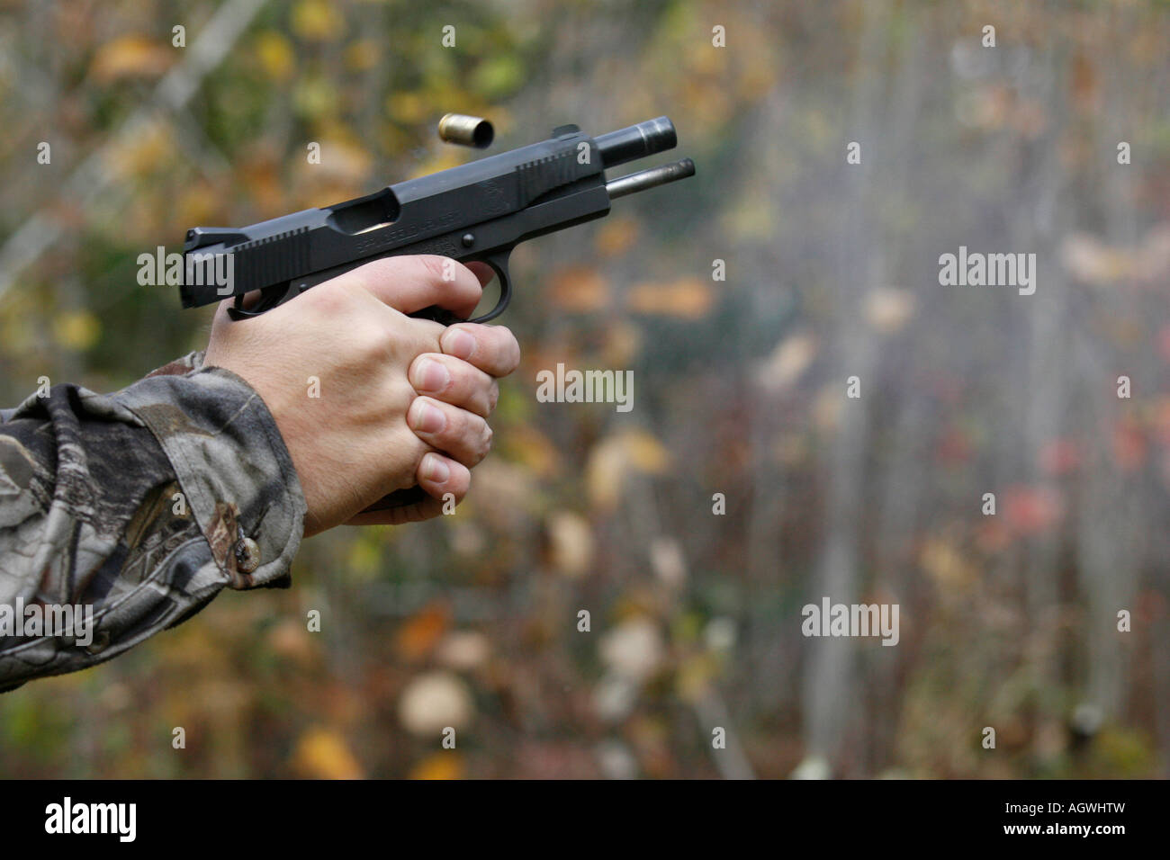 Semi-auto pistol being shot and the empty shell being ejected Stock ...