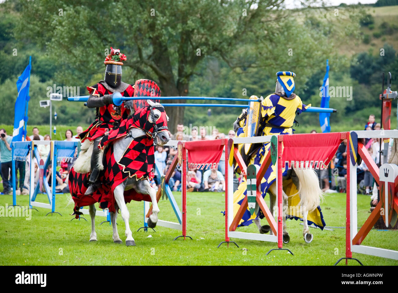 Red and yellow knights jousting on horseback at medieval reenactment tournament Stock Photo - Alamy