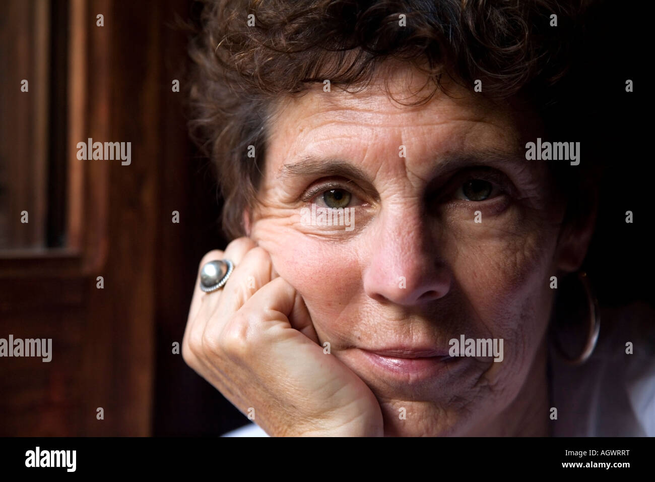 Caucasian woman (56) in window light in a restaurant Stock Photo - Alamy