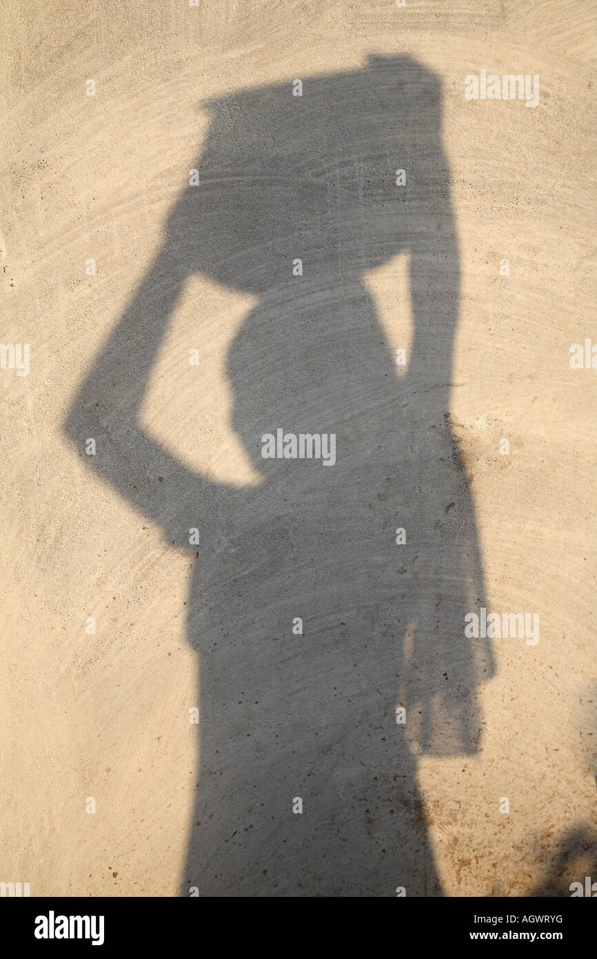 shadow on wall of indian woman with waterpot Stock Photo - Alamy