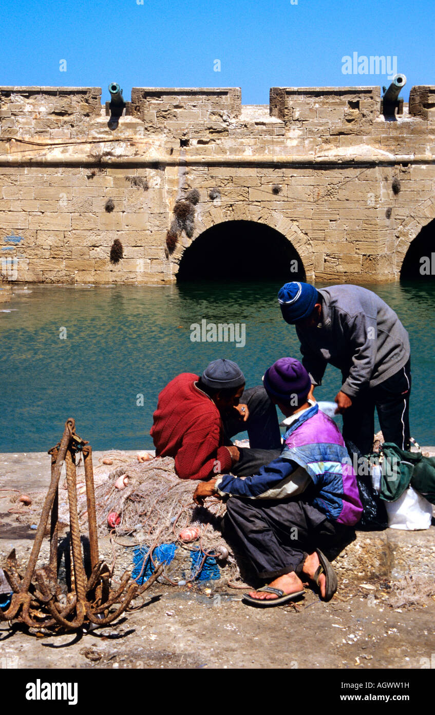 Fishermen chatting near historic defensive structures in the coastal ...
