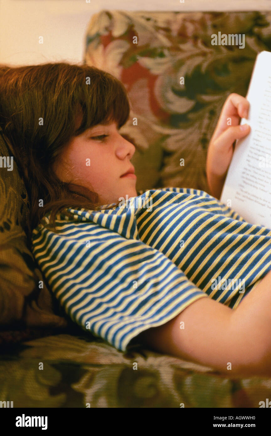 Head and torso shot of a brown haired Caucasian preteen girl reclining ...
