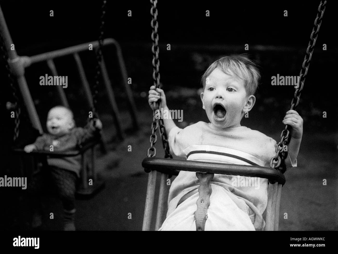 Young boy on a swing Stock Photo - Alamy