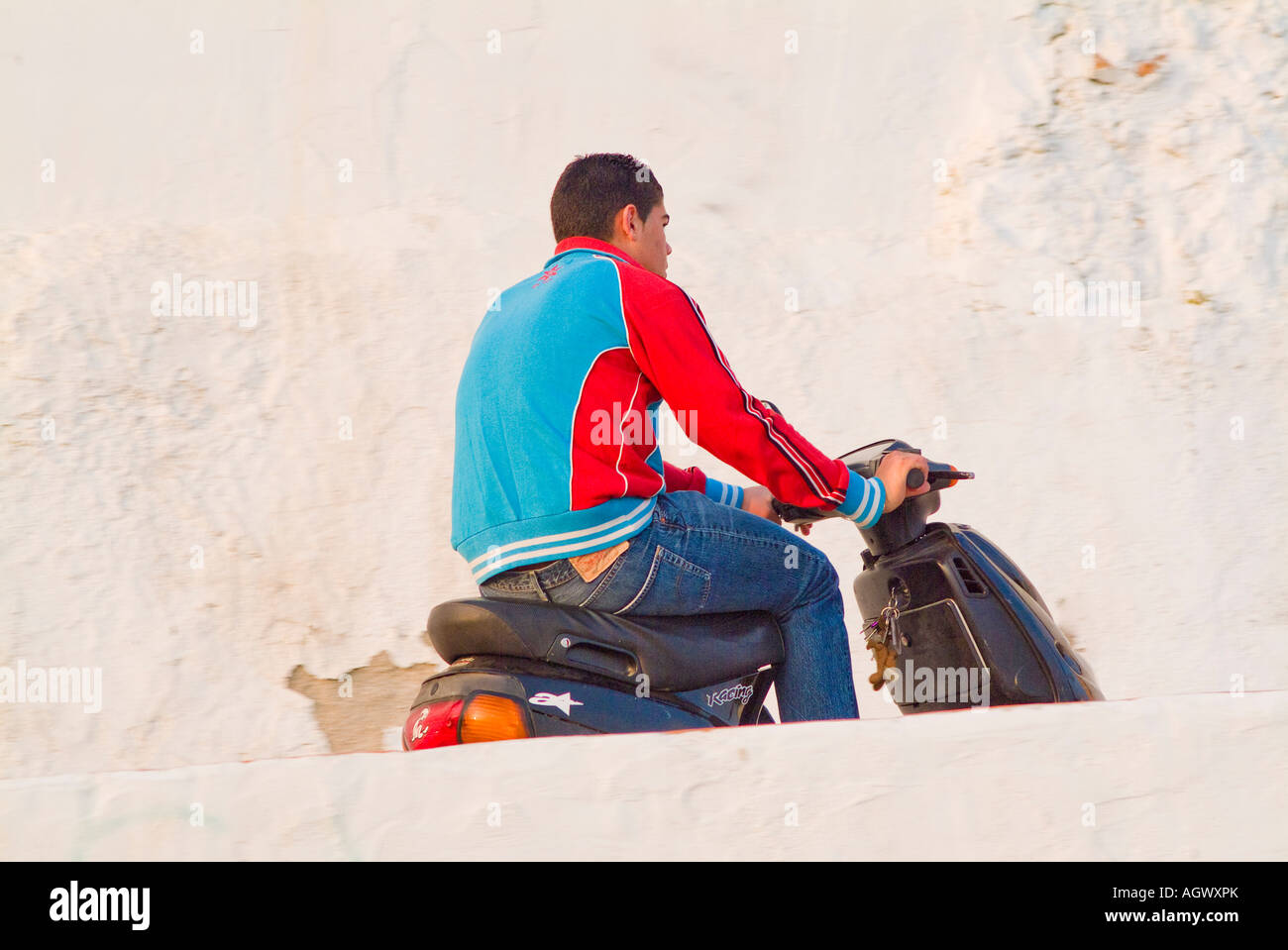 Teenage male riding a vespa uphill Stock Photo - Alamy