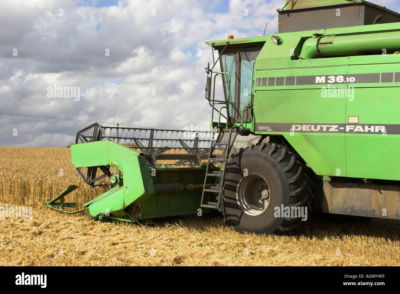 A Deutz - Fahr combine harvester at work harvesting a field of wheat ...