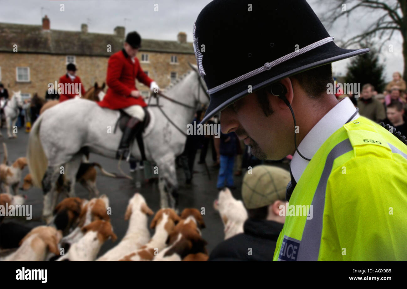 Policeman looking down at the ground in fluorescent jacket as a ...