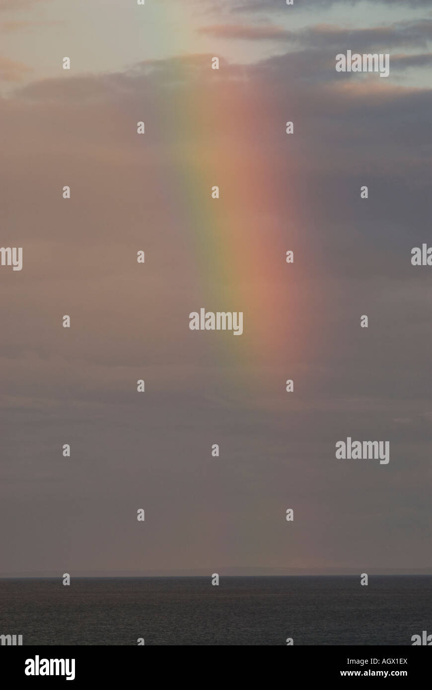 Rainbow over dark ocean Stock Photo - Alamy