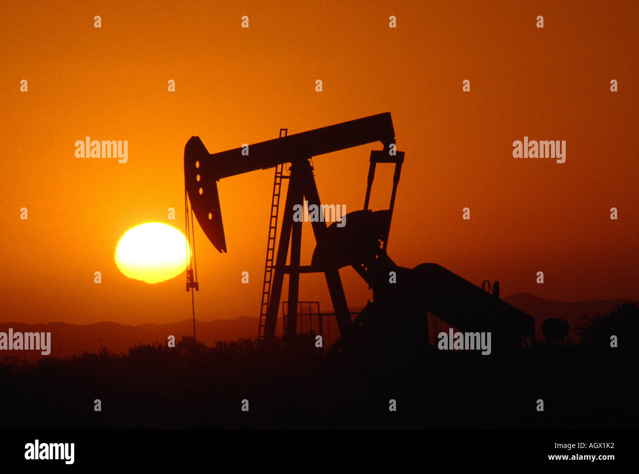 Oil drilling at sunset Stock Photo - Alamy