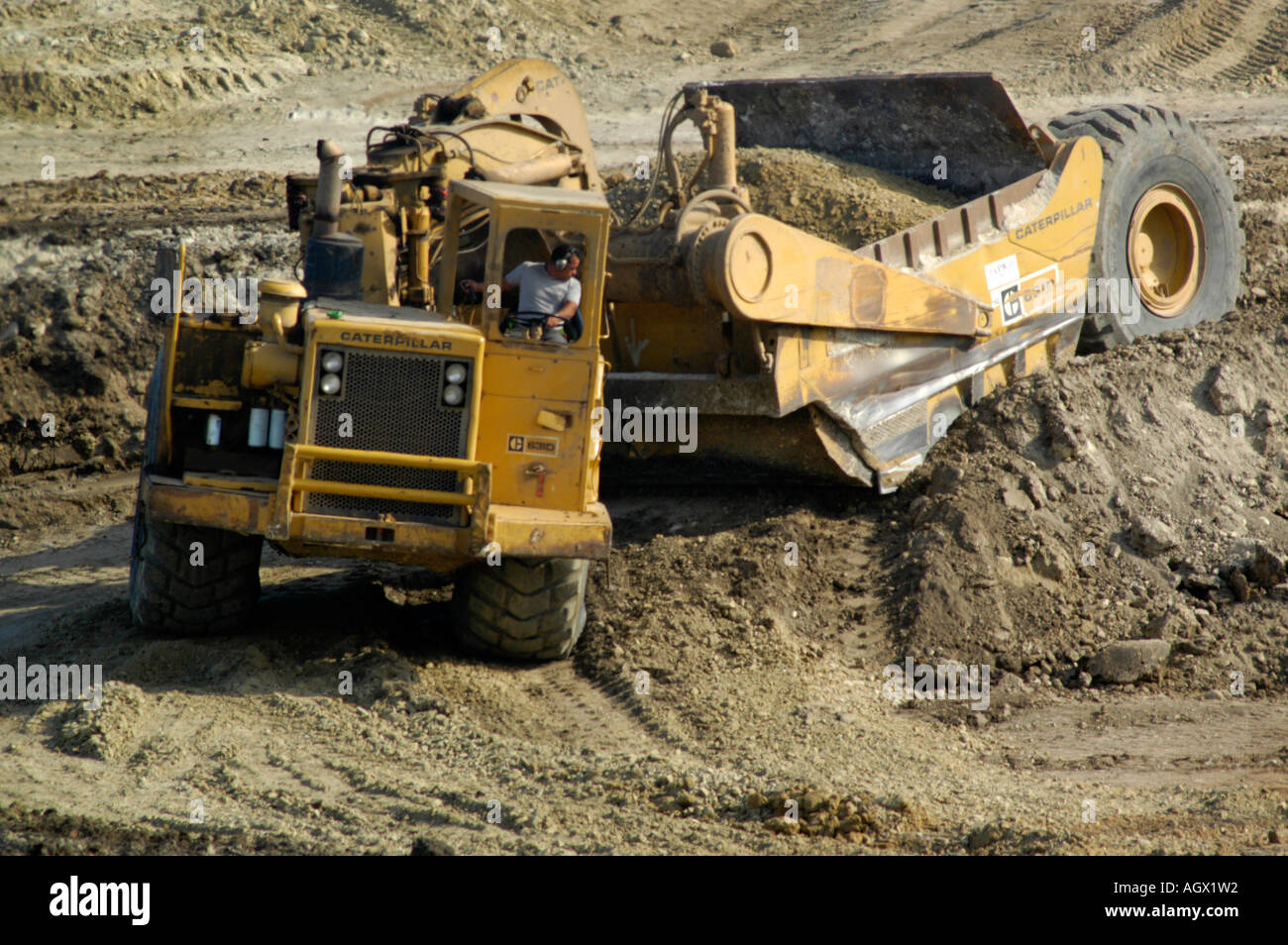 An earthmover carries dirt from a construction project Stock Photo - Alamy