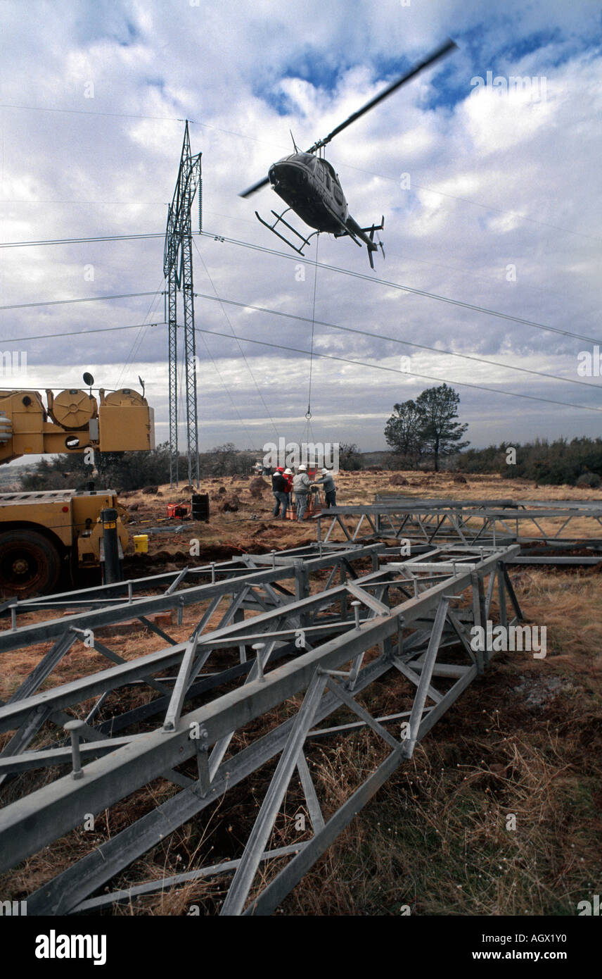A helicopter works with crew to install power lines in northern ...
