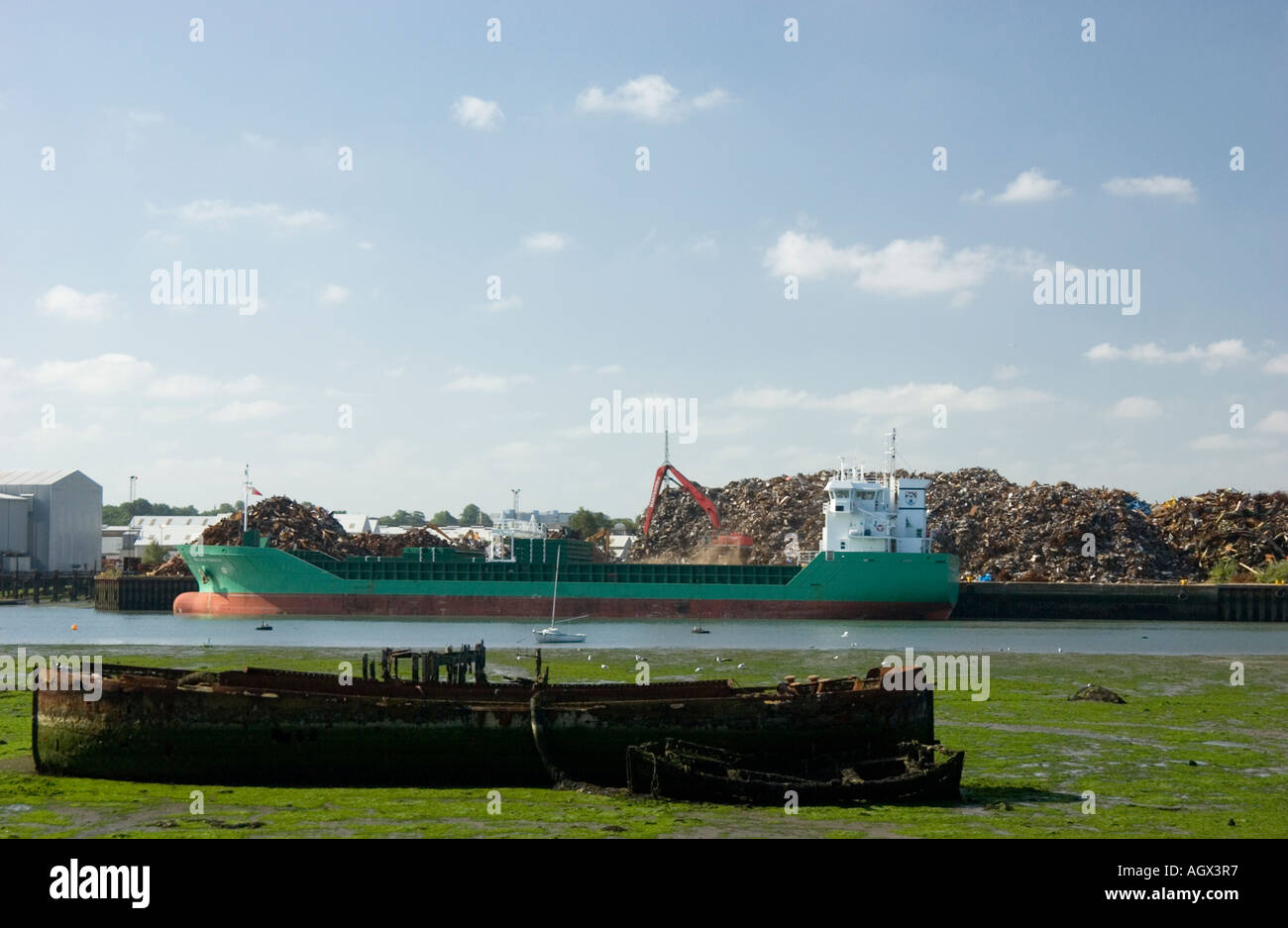 Loading scrap steel into a ship Stock Photo - Alamy
