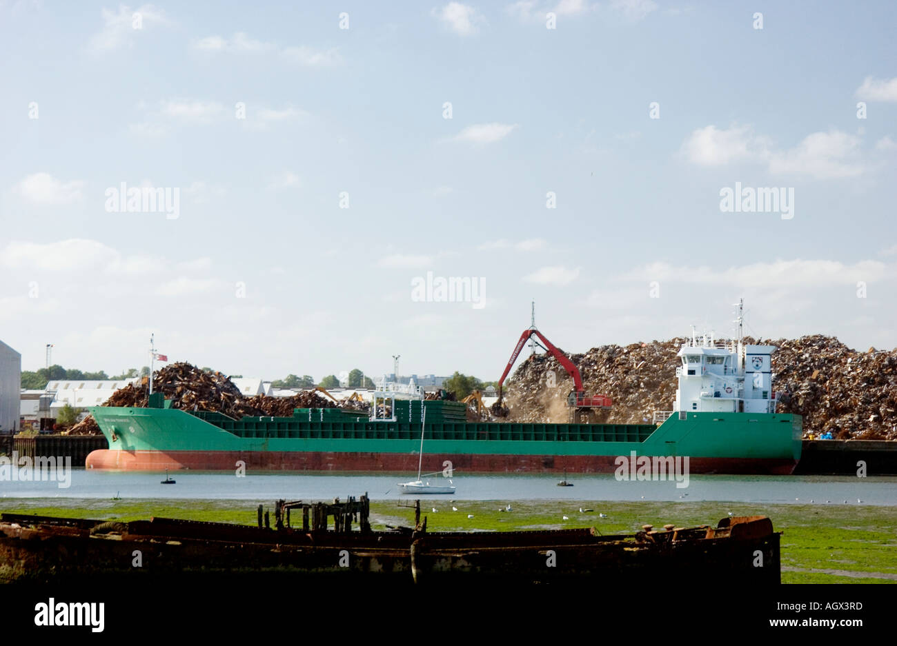 Loading scrap steel into a ship Stock Photo - Alamy