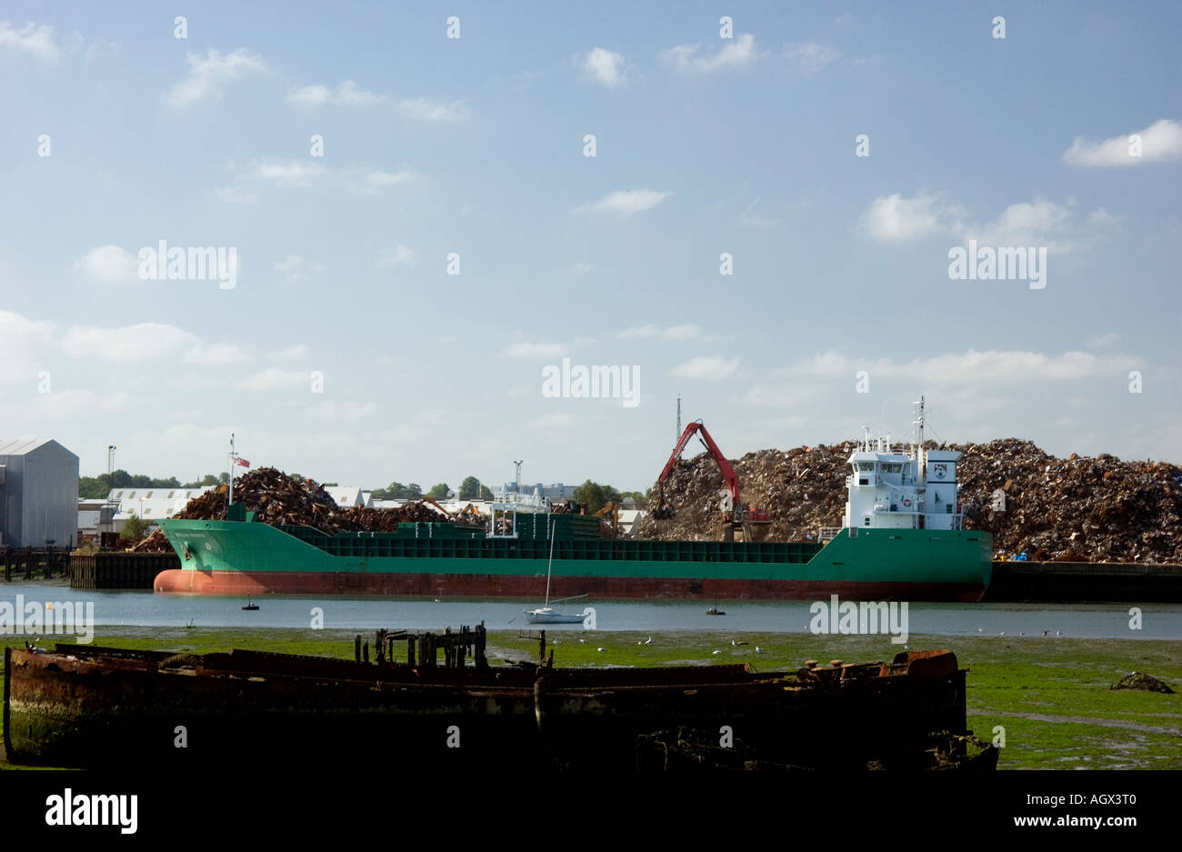 Loading scrap steel into a ship Stock Photo - Alamy