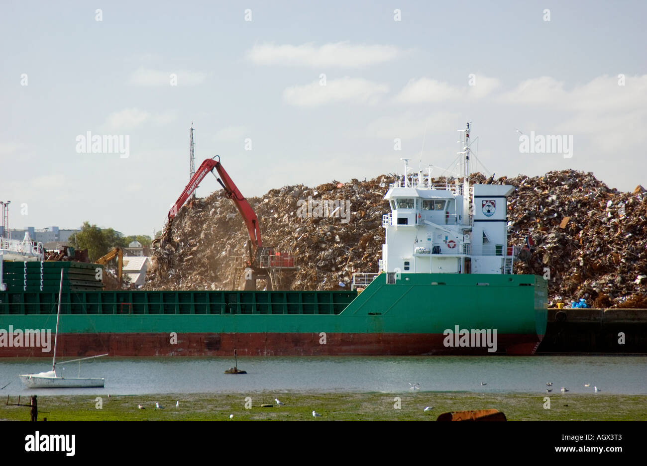 Loading scrap steel into a ship Stock Photo - Alamy
