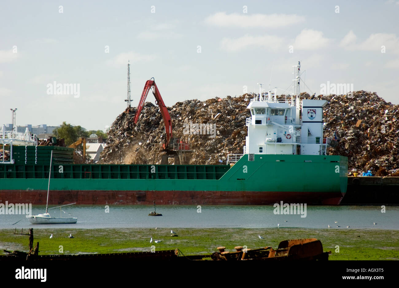Loading scrap steel into a ship Stock Photo - Alamy