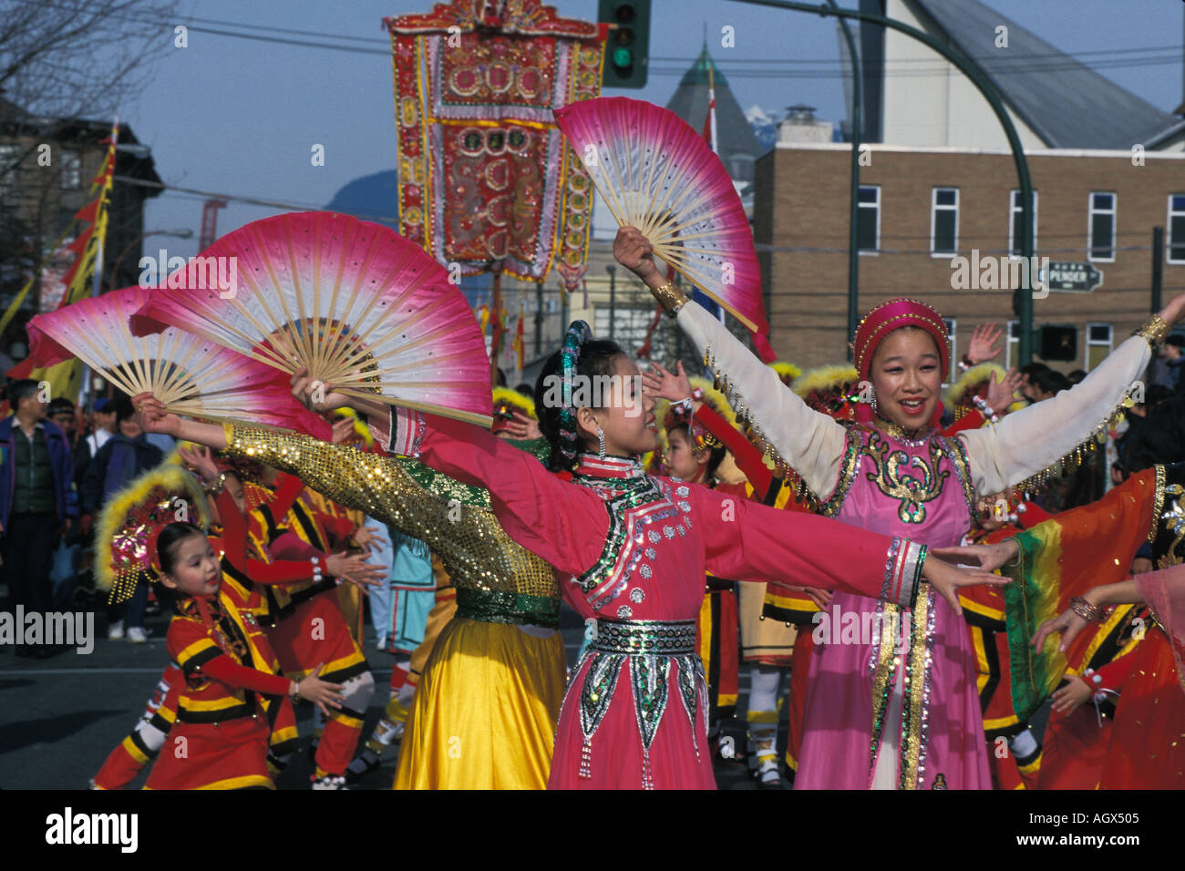 Chinese women in traditional dress dance in Chinese New Years parade ...