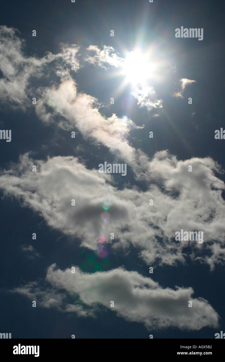 blue sky and mottled clouds with sun flare Stock Photo - Alamy