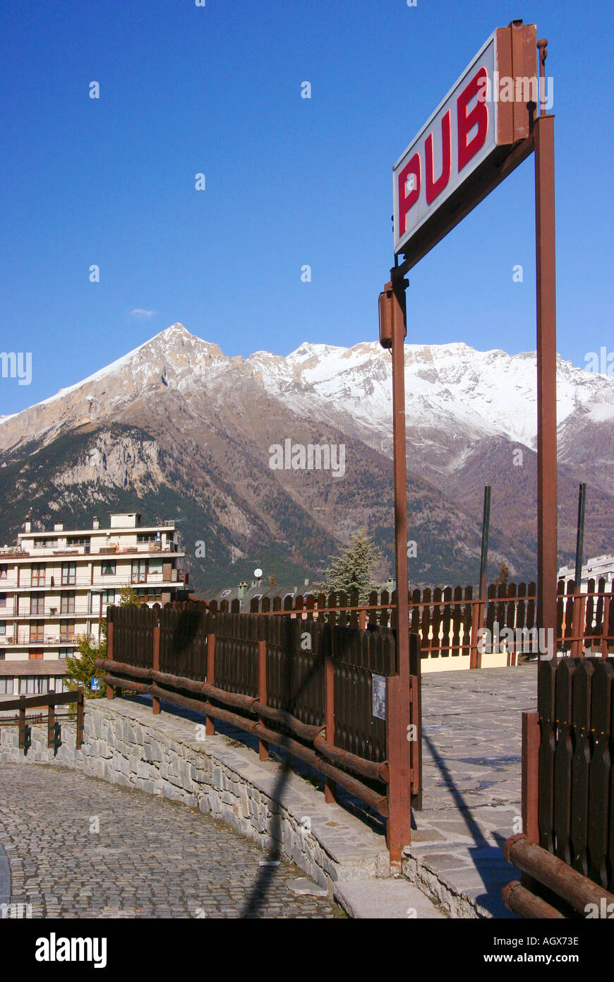 Pub sign with snow topped mountains and blue sky Susa Valley Sauze d ...