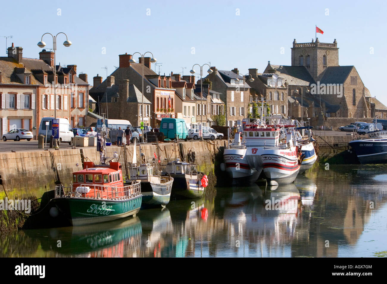 Fishing boats docked in the harbor at the village of Barfleur in the ...