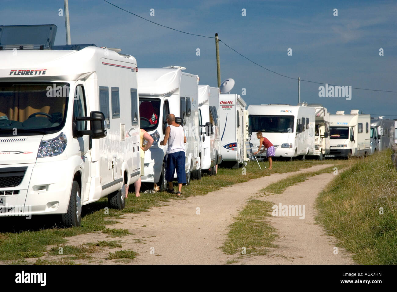 European caravans parked in a line at the village of Barfleur in the ...