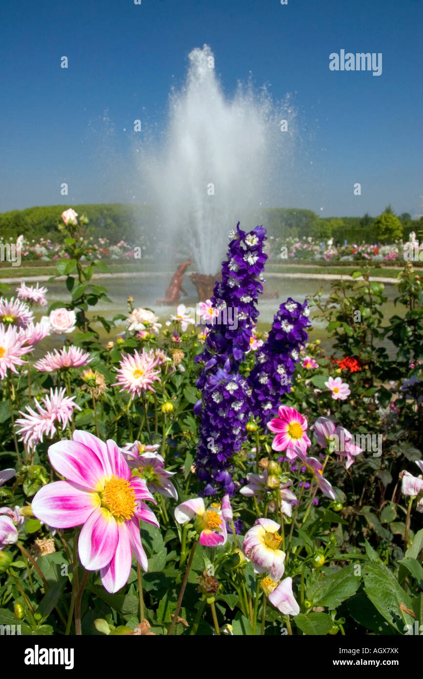 Flowers and fountains in the gardens at The Palace of Versailles at ...