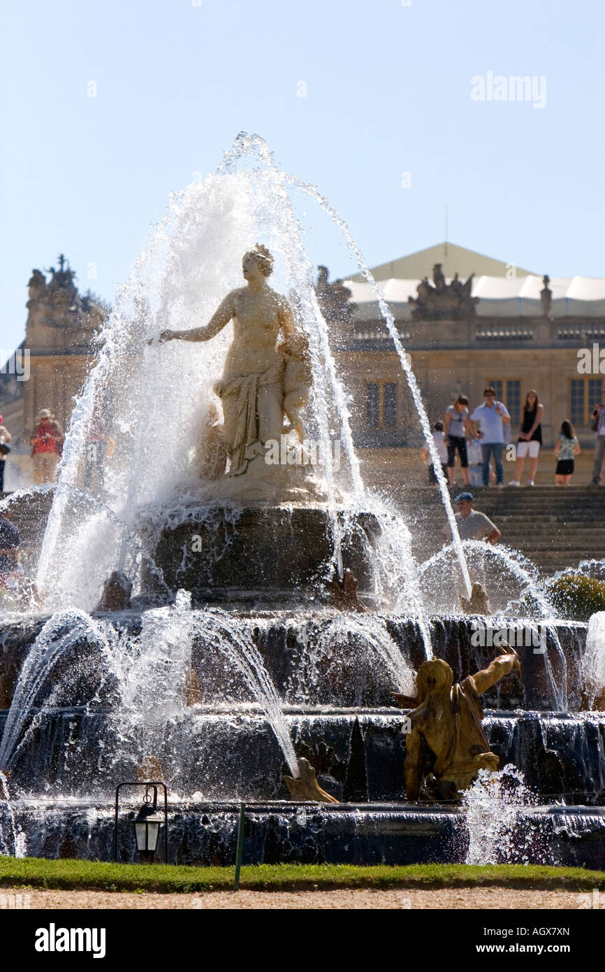 A water fountain in the formal gardens at The Palace of Versailles at ...