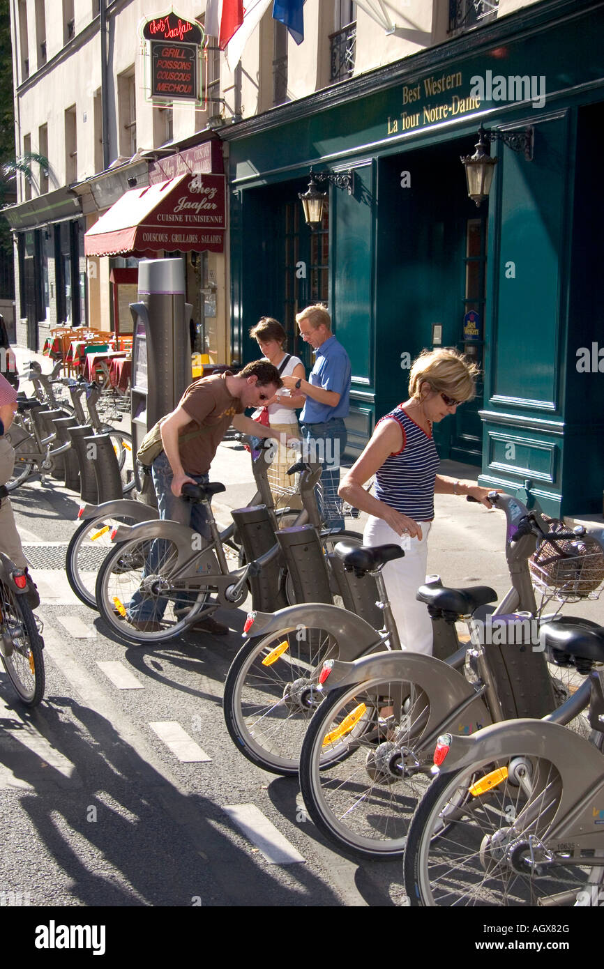 People use rental bicycles that are a part of the Velib bike transit ...
