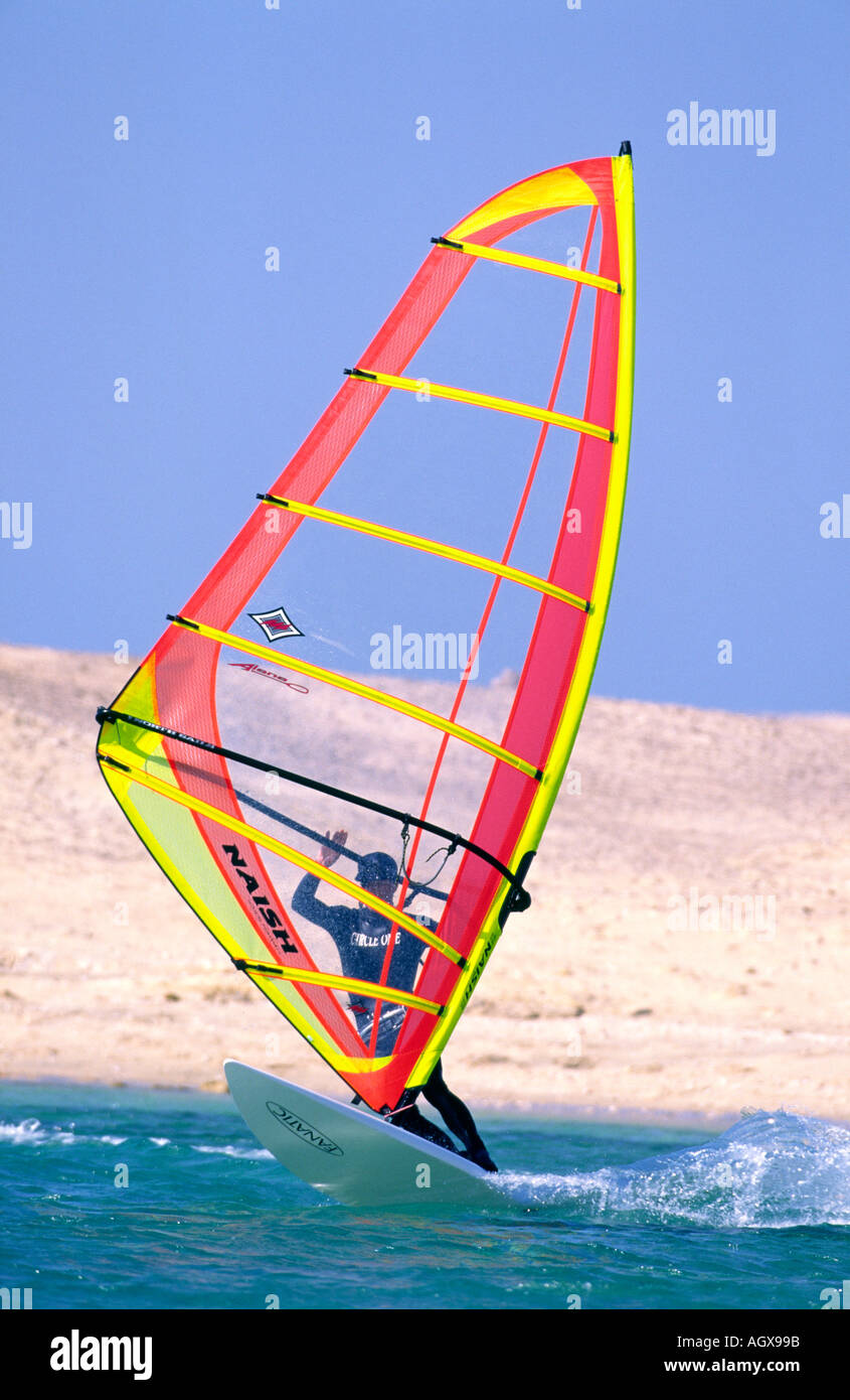 Solo adult windsurfer sailing fast on the Red Sea at Moon Beach resort ...