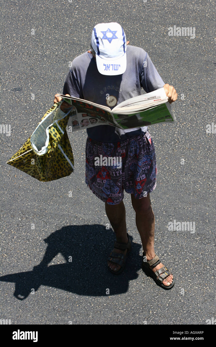 Israel man reading a Hebrew newspaper wearing a cap with the star of ...