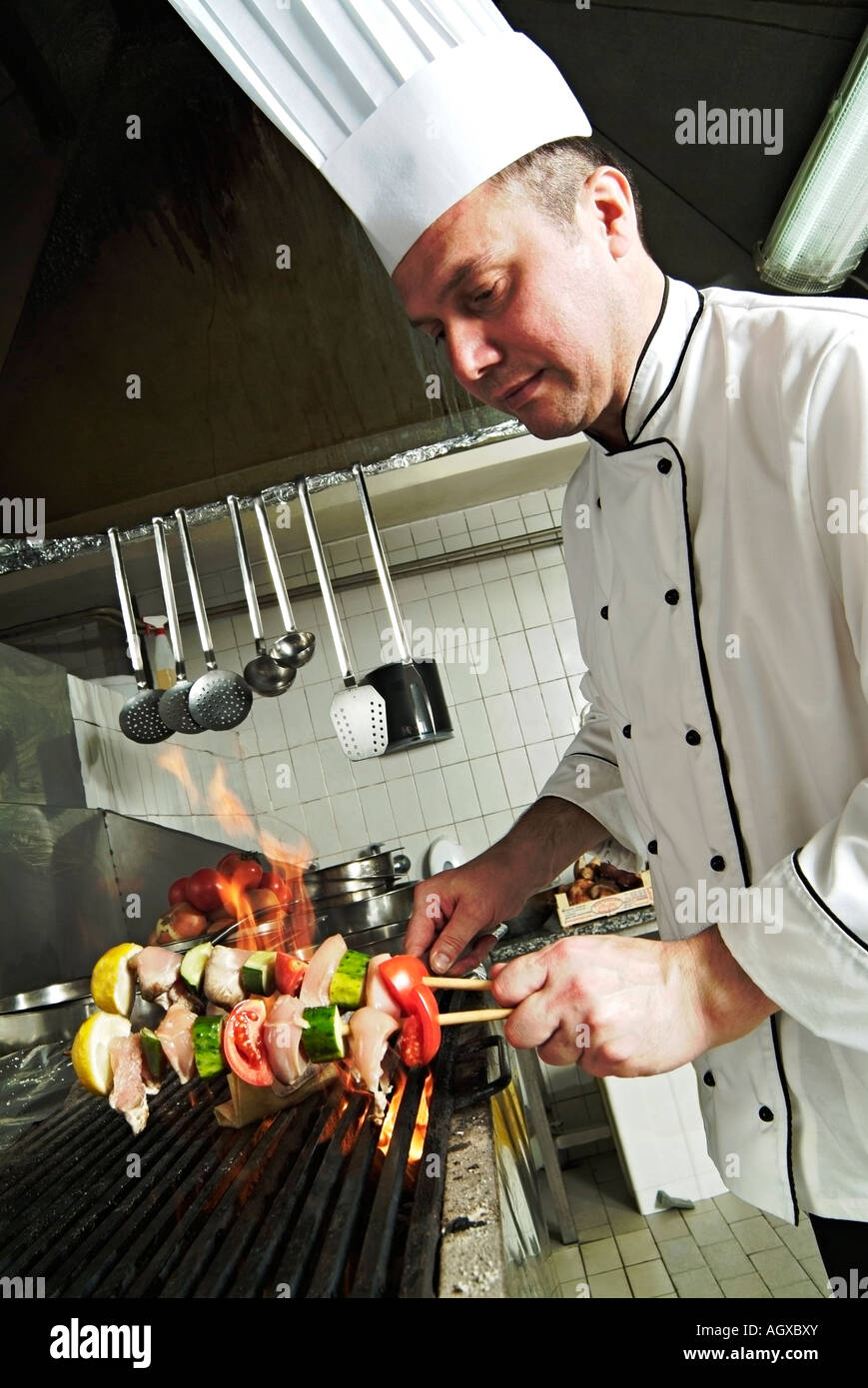 Chef Cooking Chicken Kebabs in a Restaurant Kitchen Stock Photo - Alamy