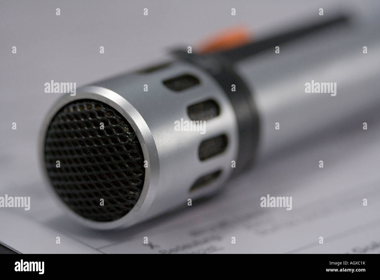 closeup of microphone lying on sheet of paper Stock Photo - Alamy