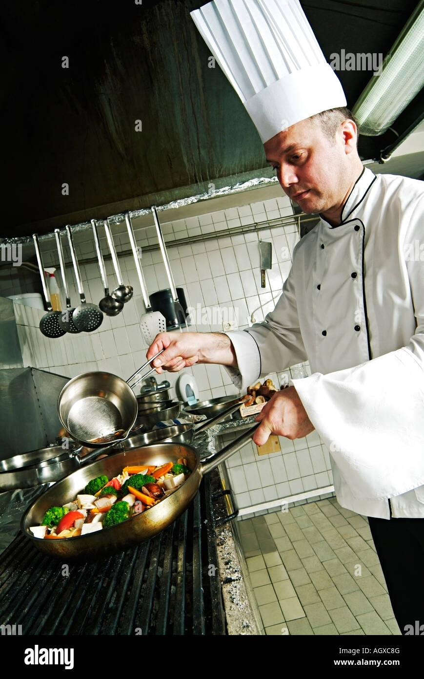 Chef Preparing a Meal in a Restaurant Kitchen Stock Photo - Alamy