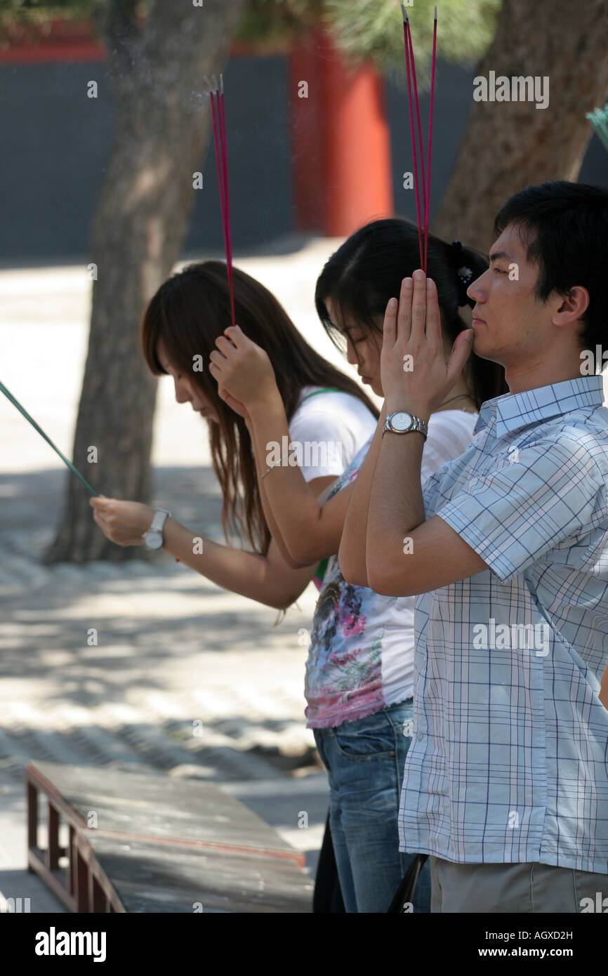 young chinese Buddhist praying in Lama temple Beijing China August 2007 ...