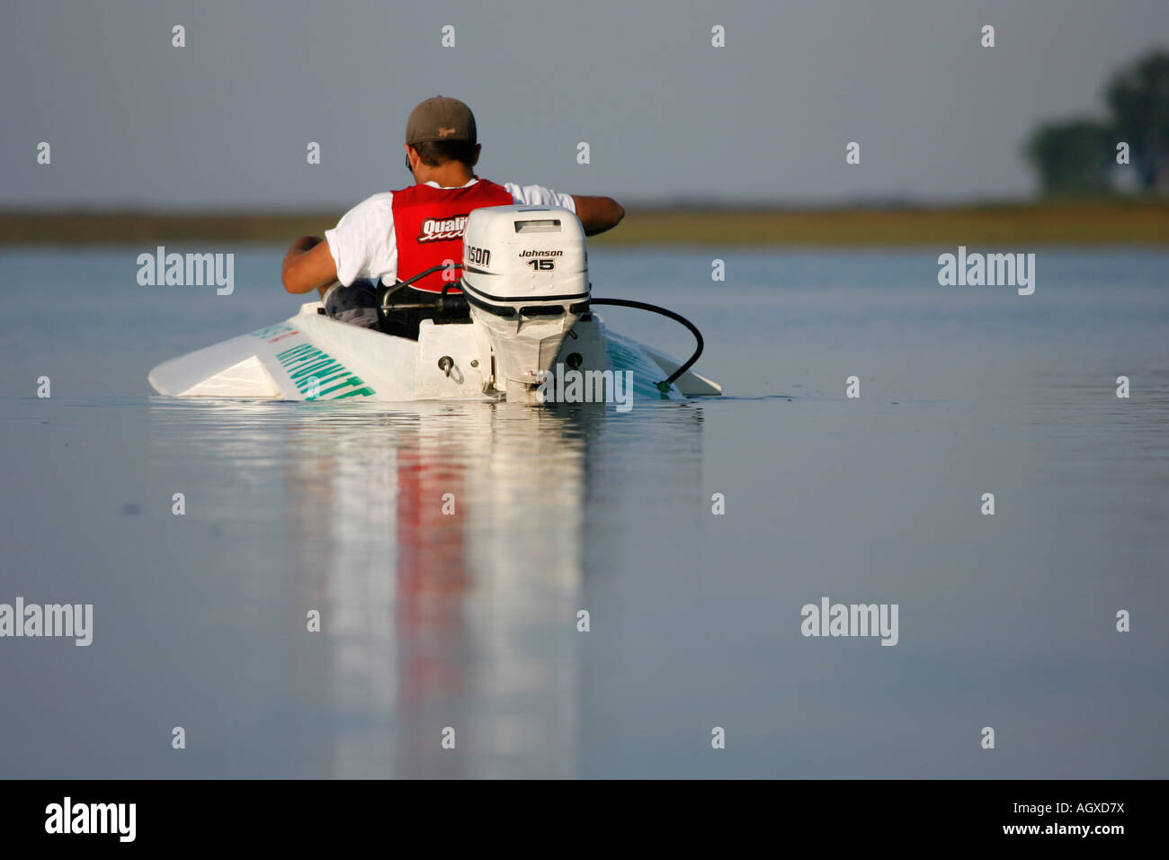 Teenage boy getting ready to drive his hydroplane Stock Photo - Alamy