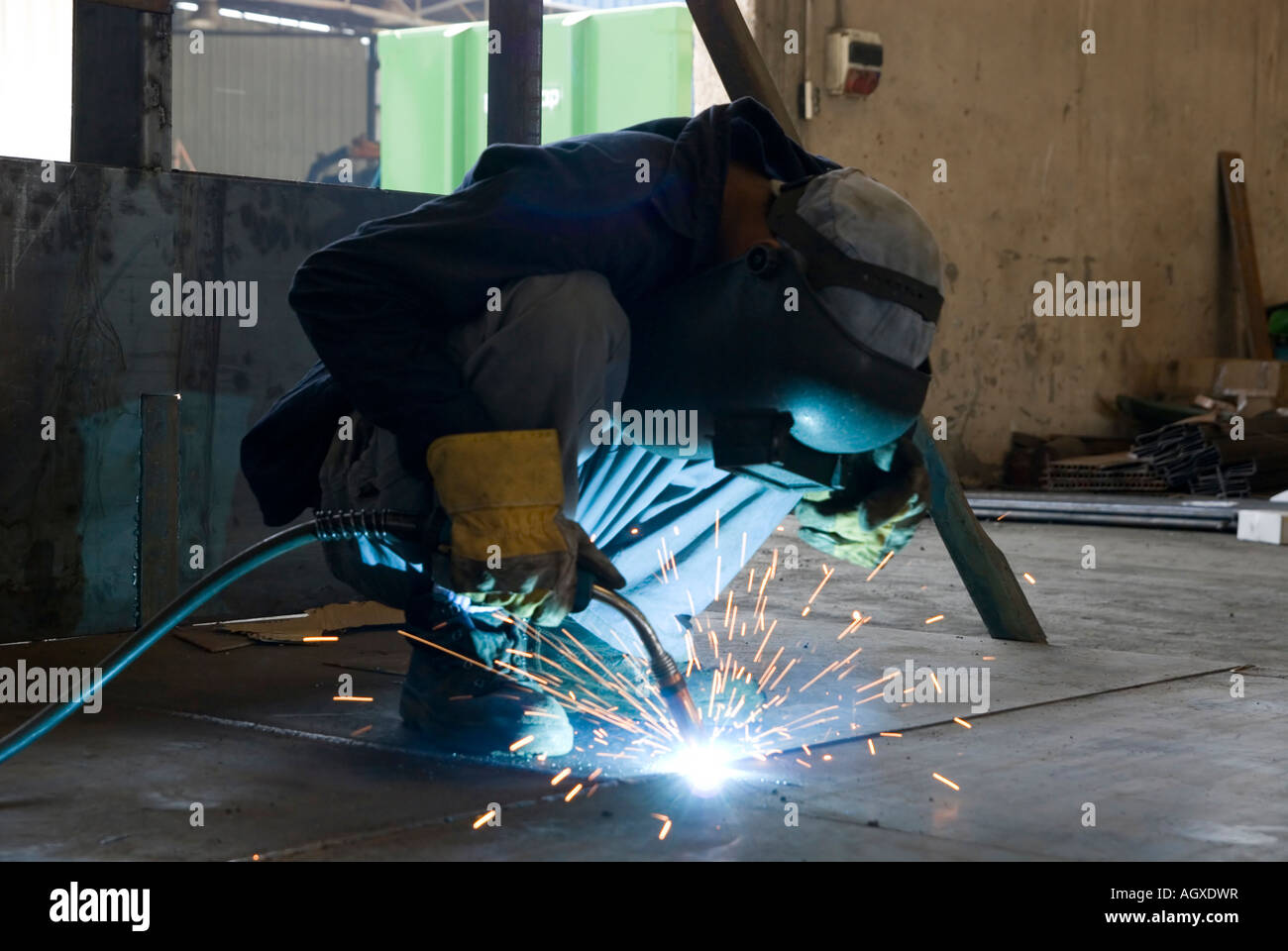 A worker welding metal plates Stock Photo - Alamy