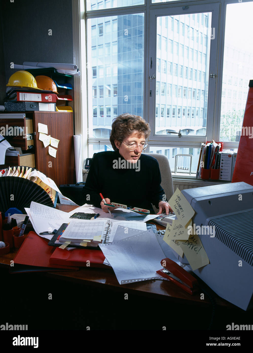 Woman office files busy computer hi-res stock photography and images ...