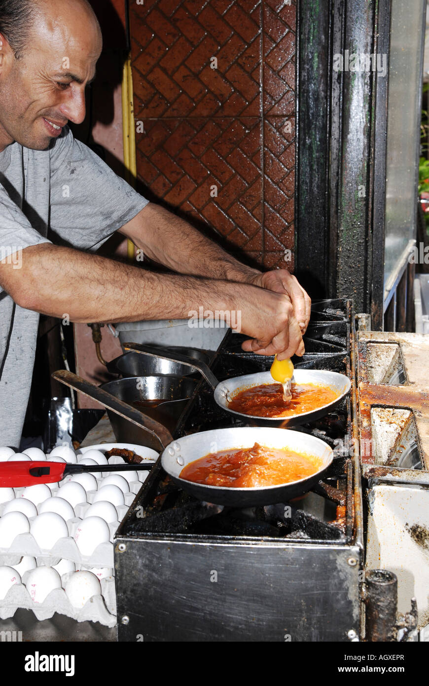 Israel Jaffa cooking Shakshuka a fried egg dish with tomatoes and ...
