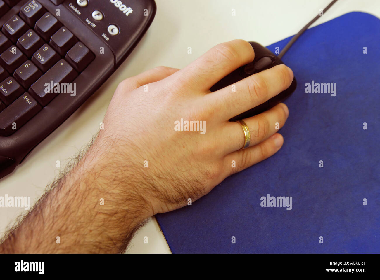 Male hand holding a computer mouse near a black keyboard Stock Photo ...