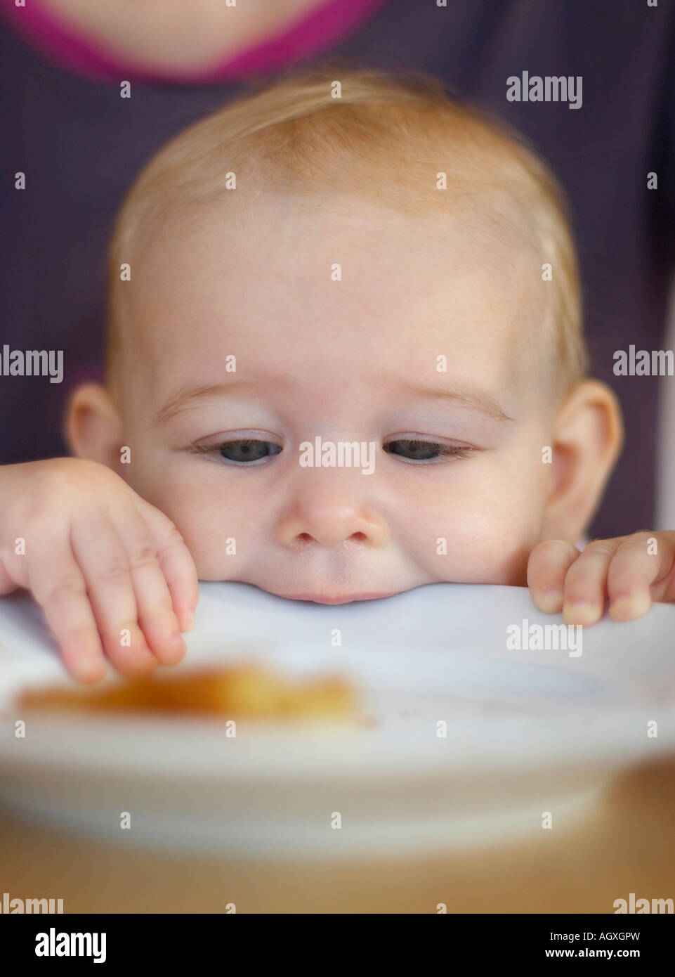 Toddler biting food hi-res stock photography and images - Alamy