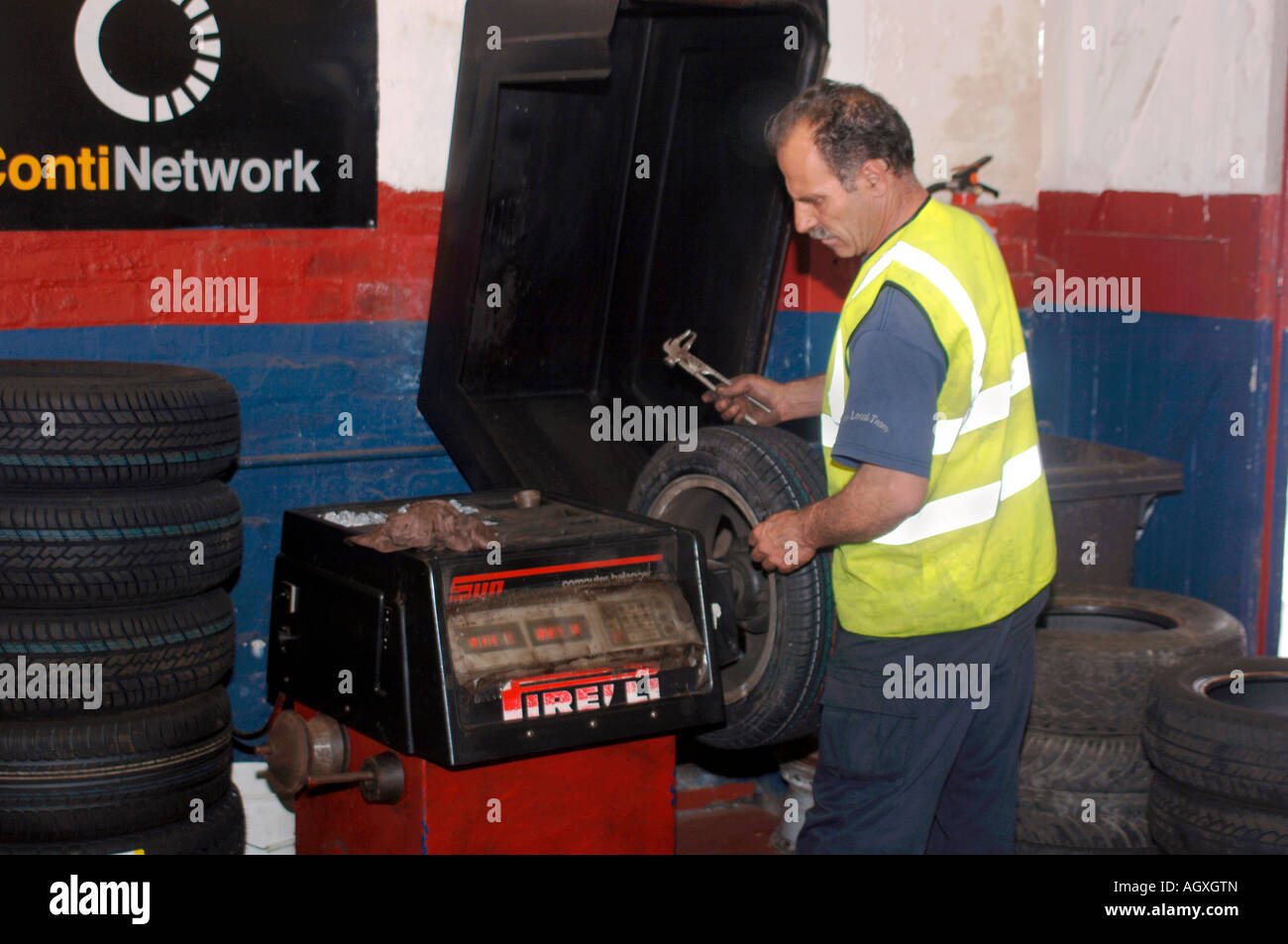 A Man At Work At A Tyre Centre Stock Photo - Alamy